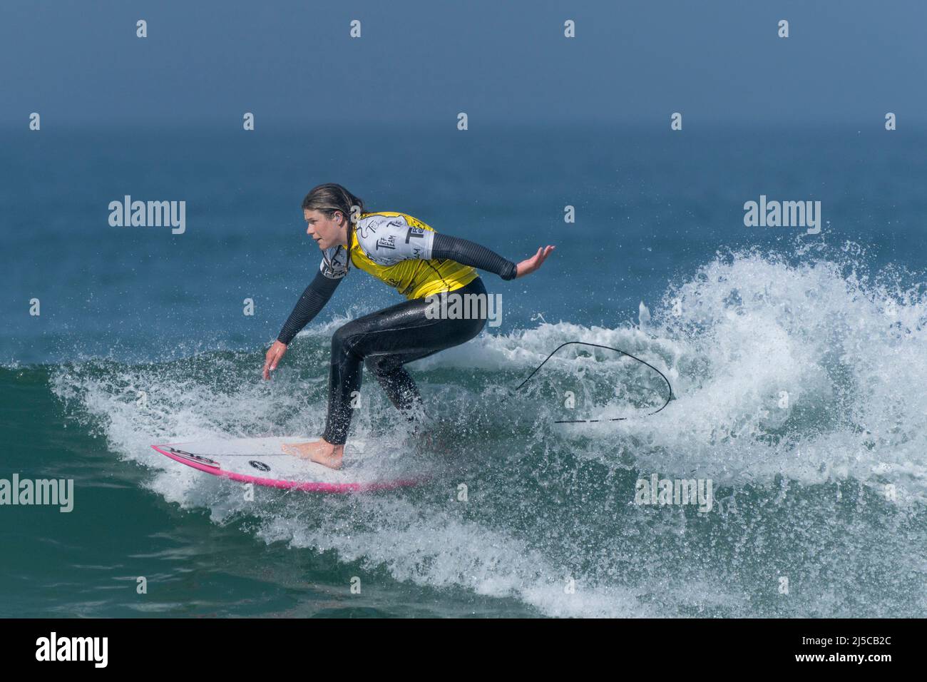 A surfer competing in a surfing competition at Fistral in Newquay in ...