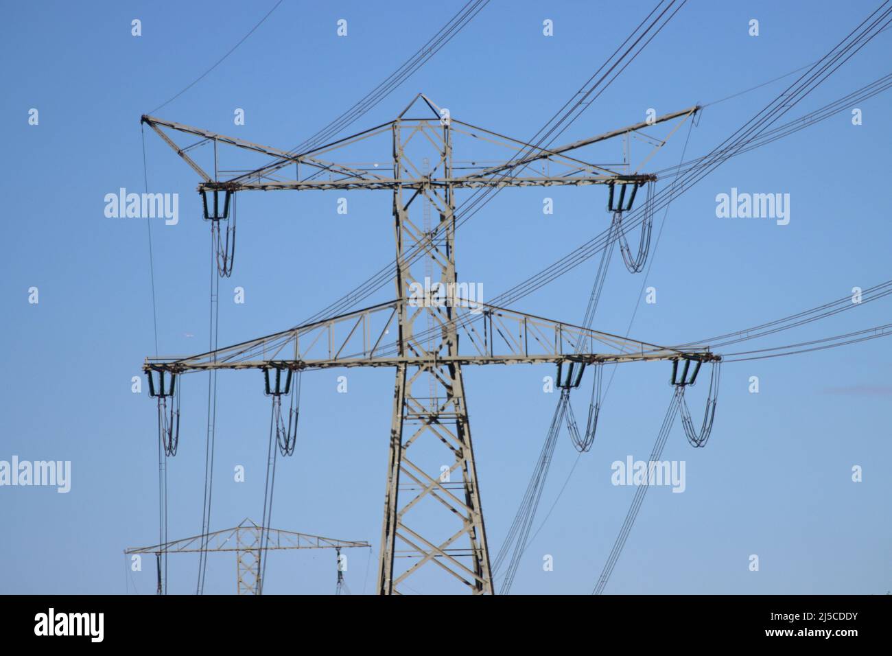 High steel pylons for high voltage power transmission Stock Photo - Alamy