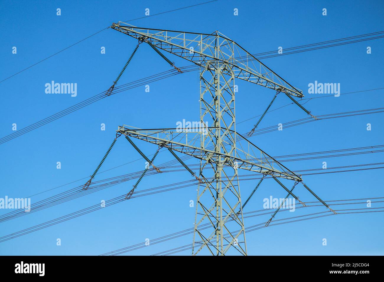High steel pylons for high voltage power transmission Stock Photo - Alamy