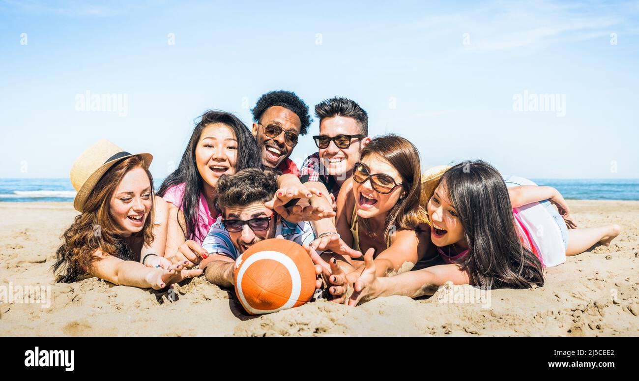 Group of multiracial happy friends having fun playing sport beach games ...