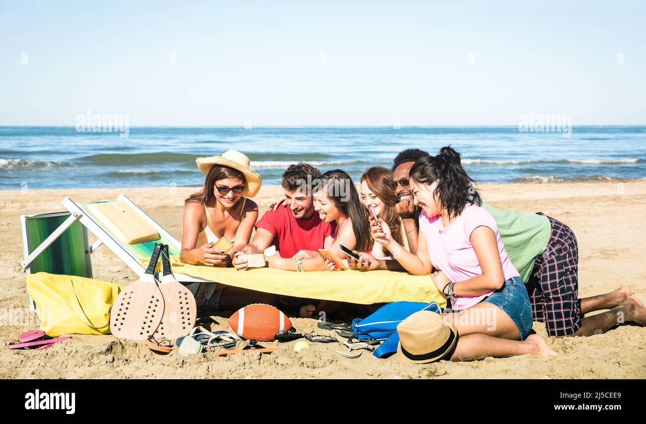 Group of multiracial friends having fun together with smartphone ...