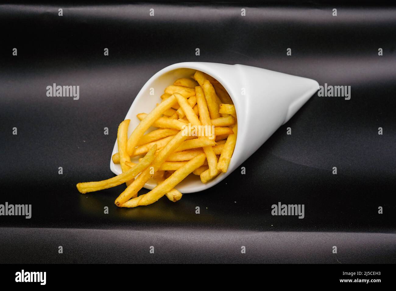 Cone with sweet potatoes and chips to eat and dip in sauce Stock Photo ...