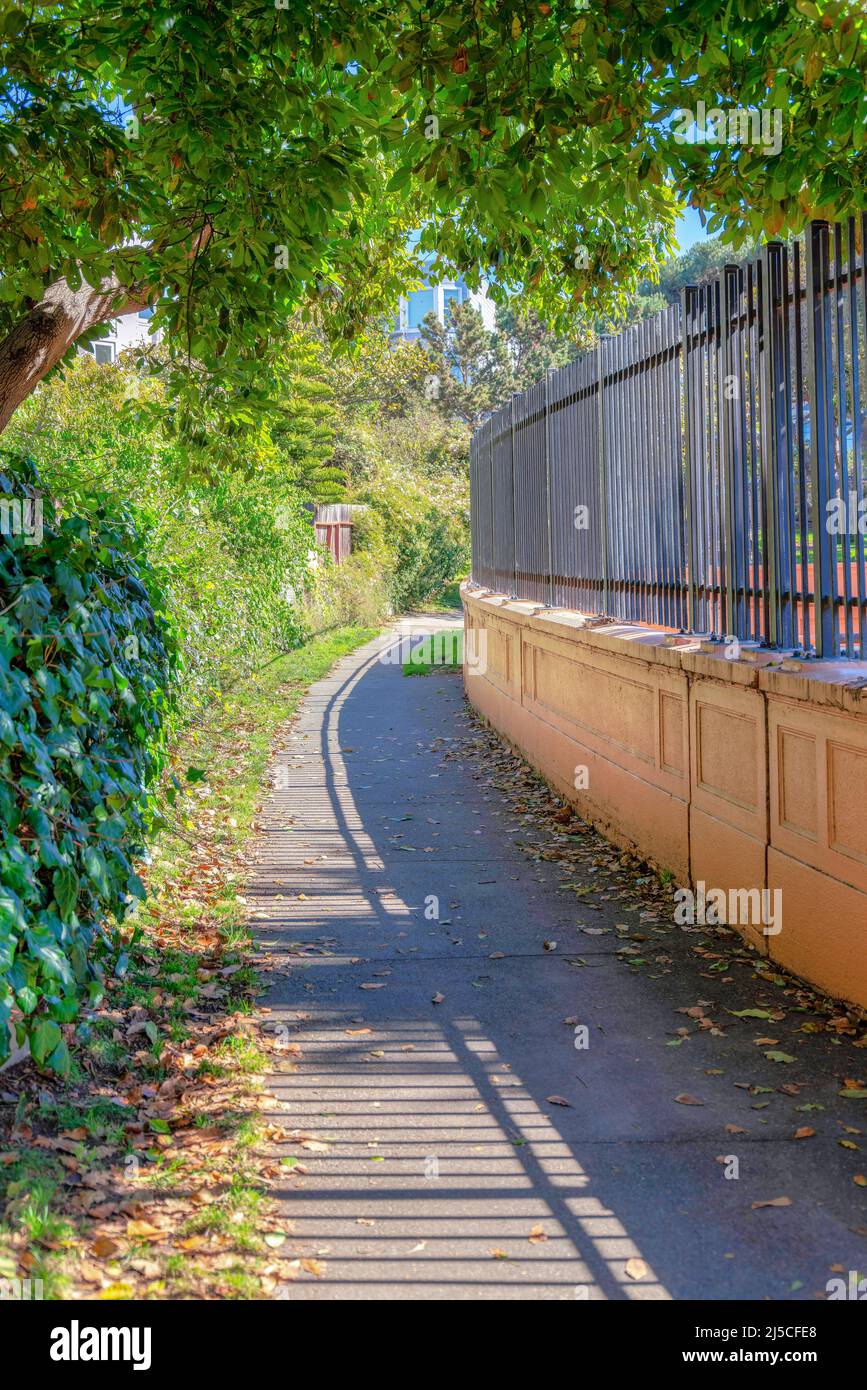 Concrete pathway outside the wall with fence at San Francisco ...