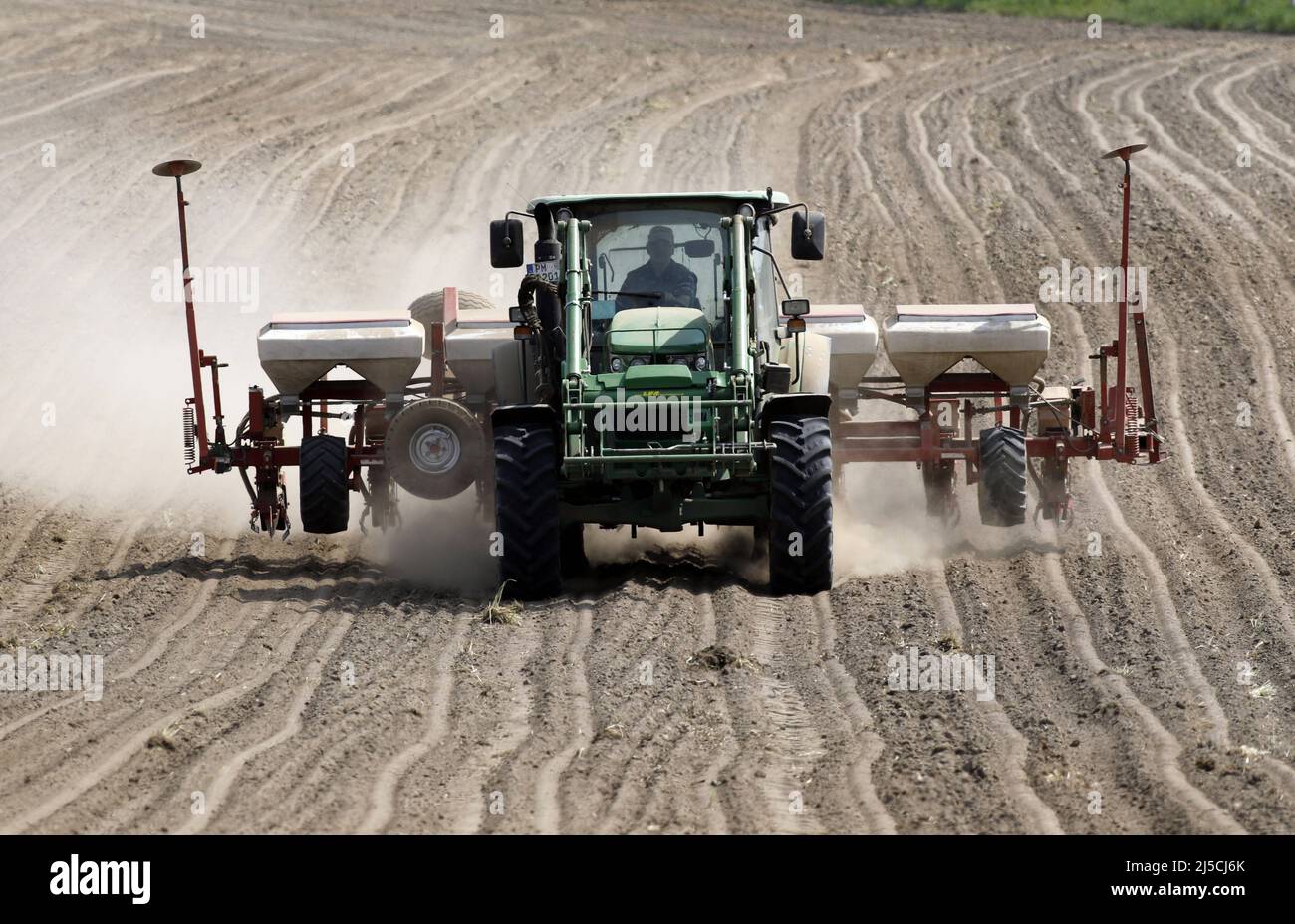 Due to the persistent drought, a tractor is dragging a large plume of ...