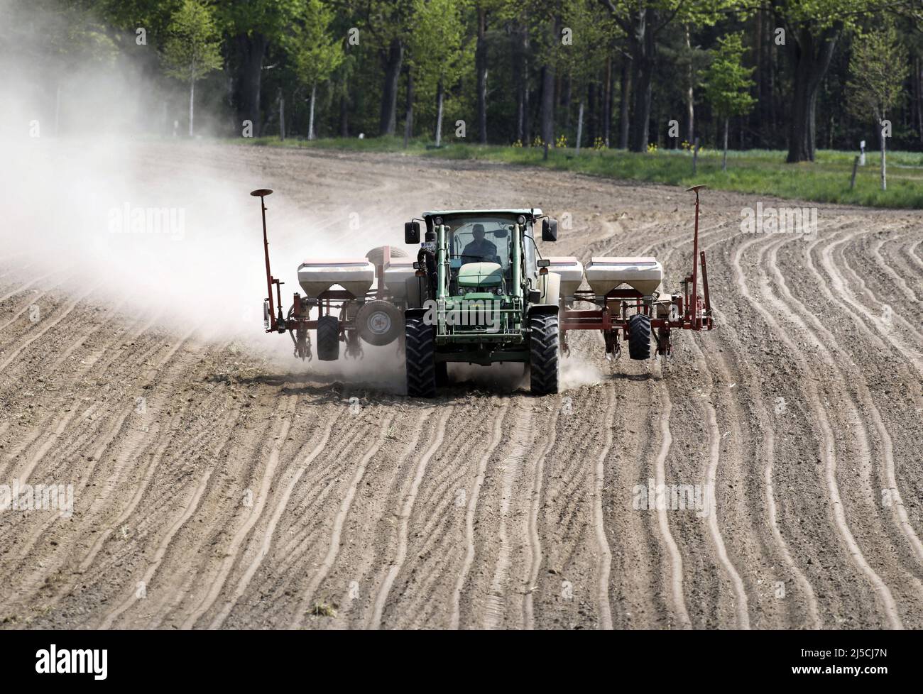 Due to the persistent drought, a tractor is dragging a large plume of ...