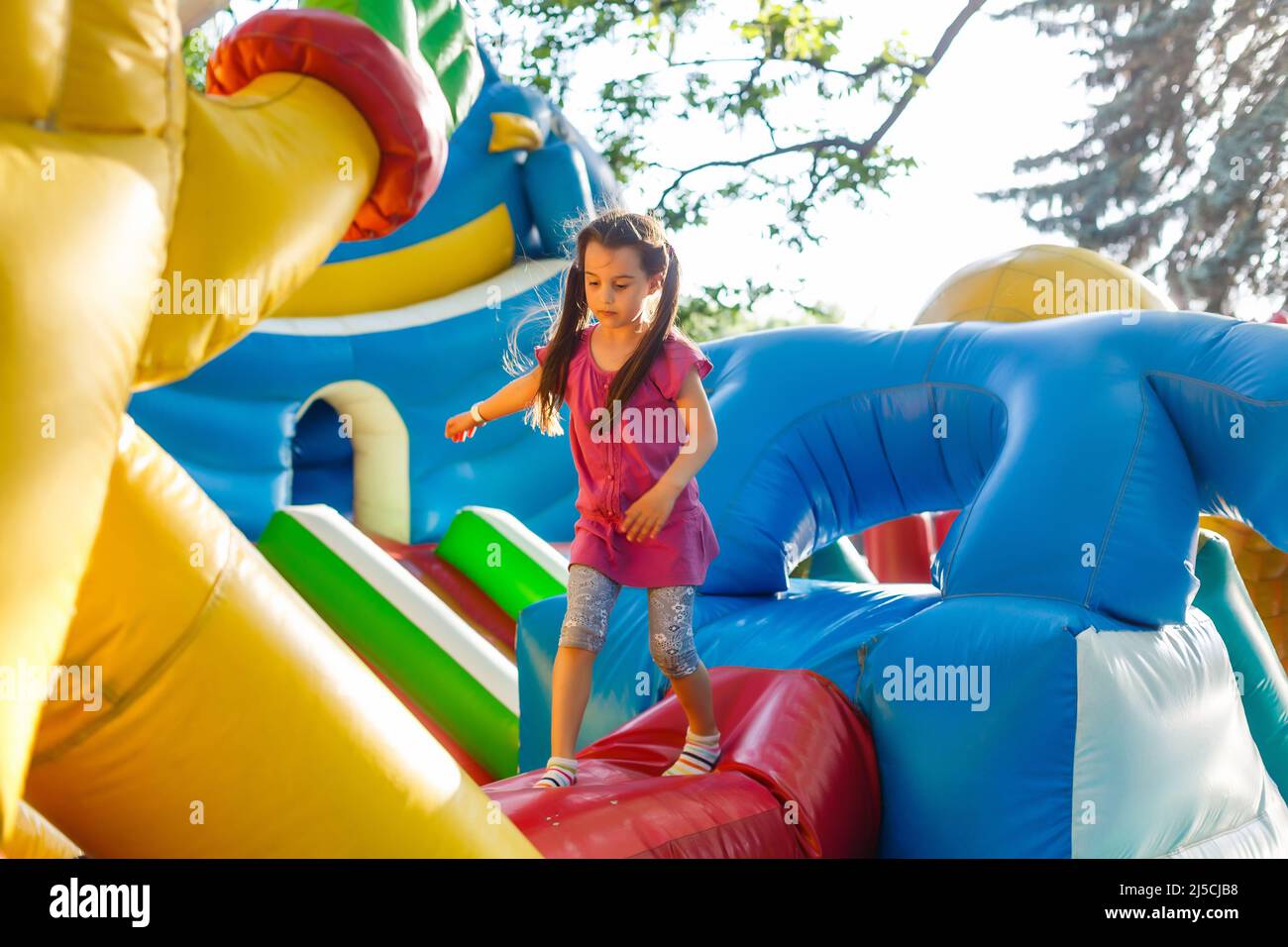 Cute little girl in amusement park Stock Photo - Alamy