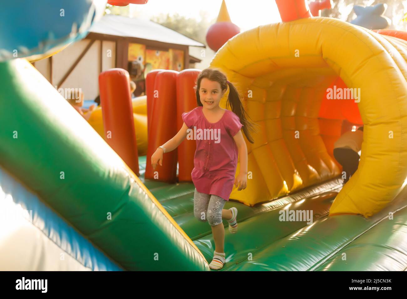 Cute little girl in amusement park Stock Photo - Alamy