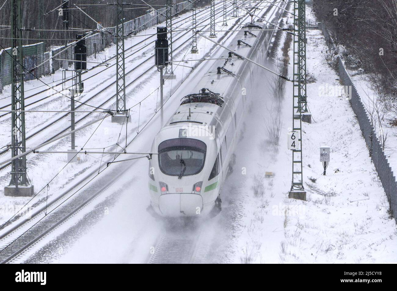 Berlin, DEU, 09.02.21 - A Deutsche Bahn ICE train drives over snow ...