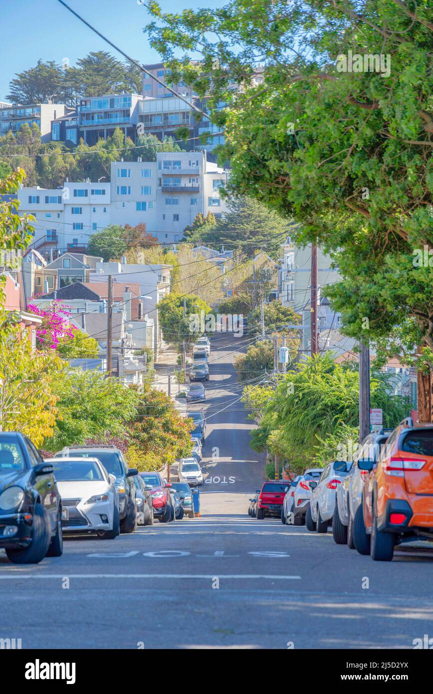 Sloped concrete road with parked vehicles on both sides at San ...