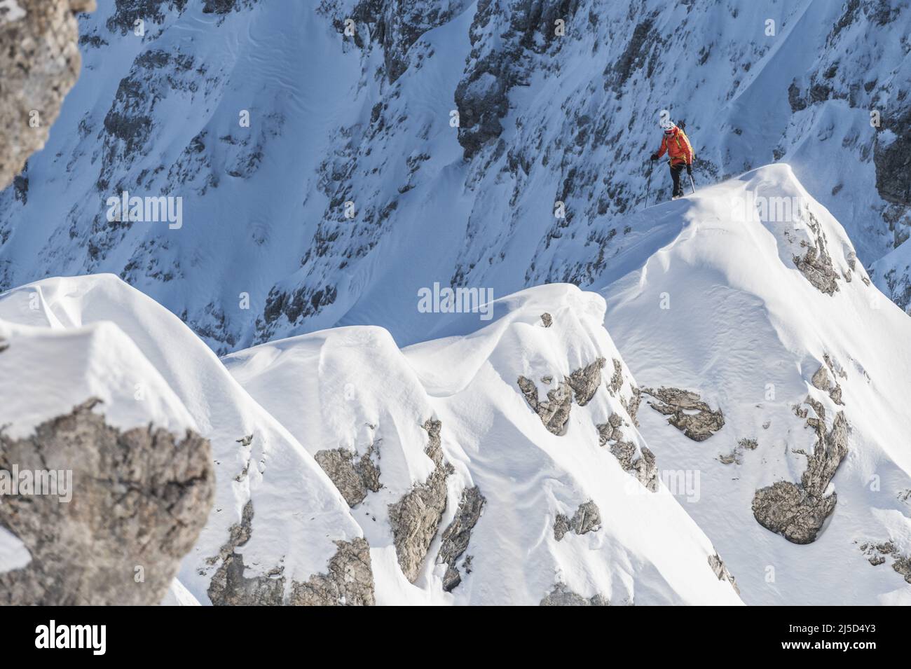 A climber on the jubilee ridge in the Zugspitz massif not far from the Zugspitz peak, winter ...