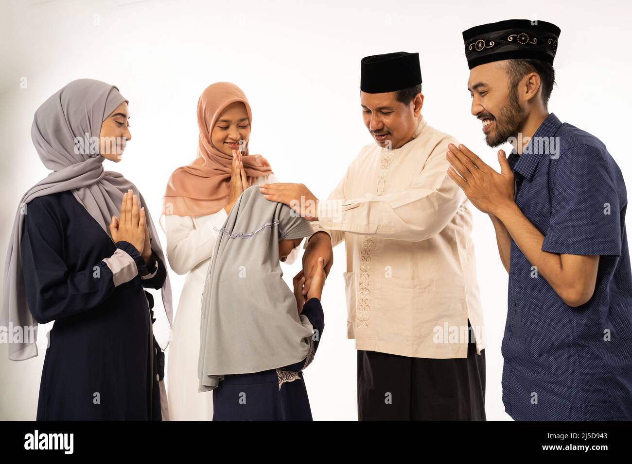 muslim family shake hand on idul fitri celebration Stock Photo - Alamy