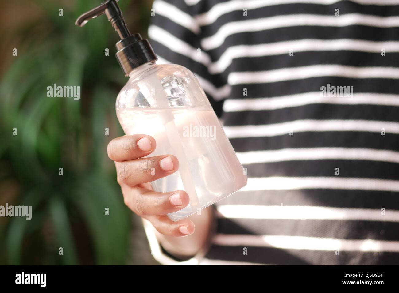 holding sanitizer liquid for preventing corona virus Stock Photo - Alamy