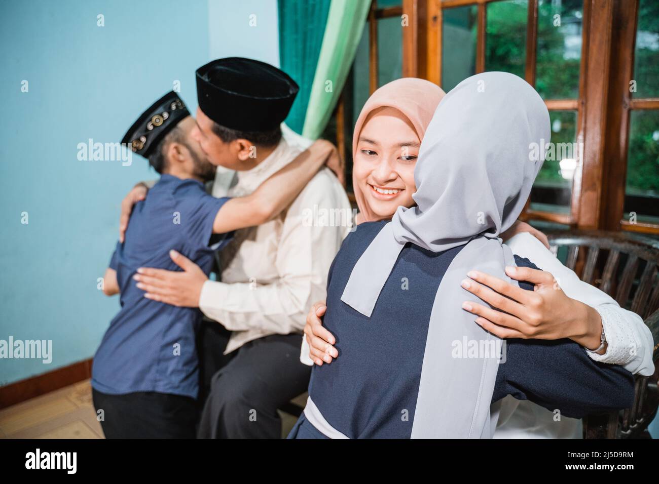 muslim family kneeling and hugging forgiving each other during eid ...
