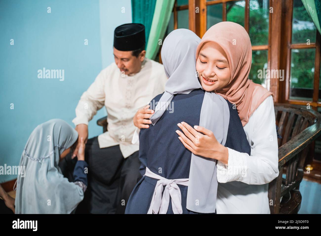 muslim family kneeling and hugging forgiving each other during eid ...