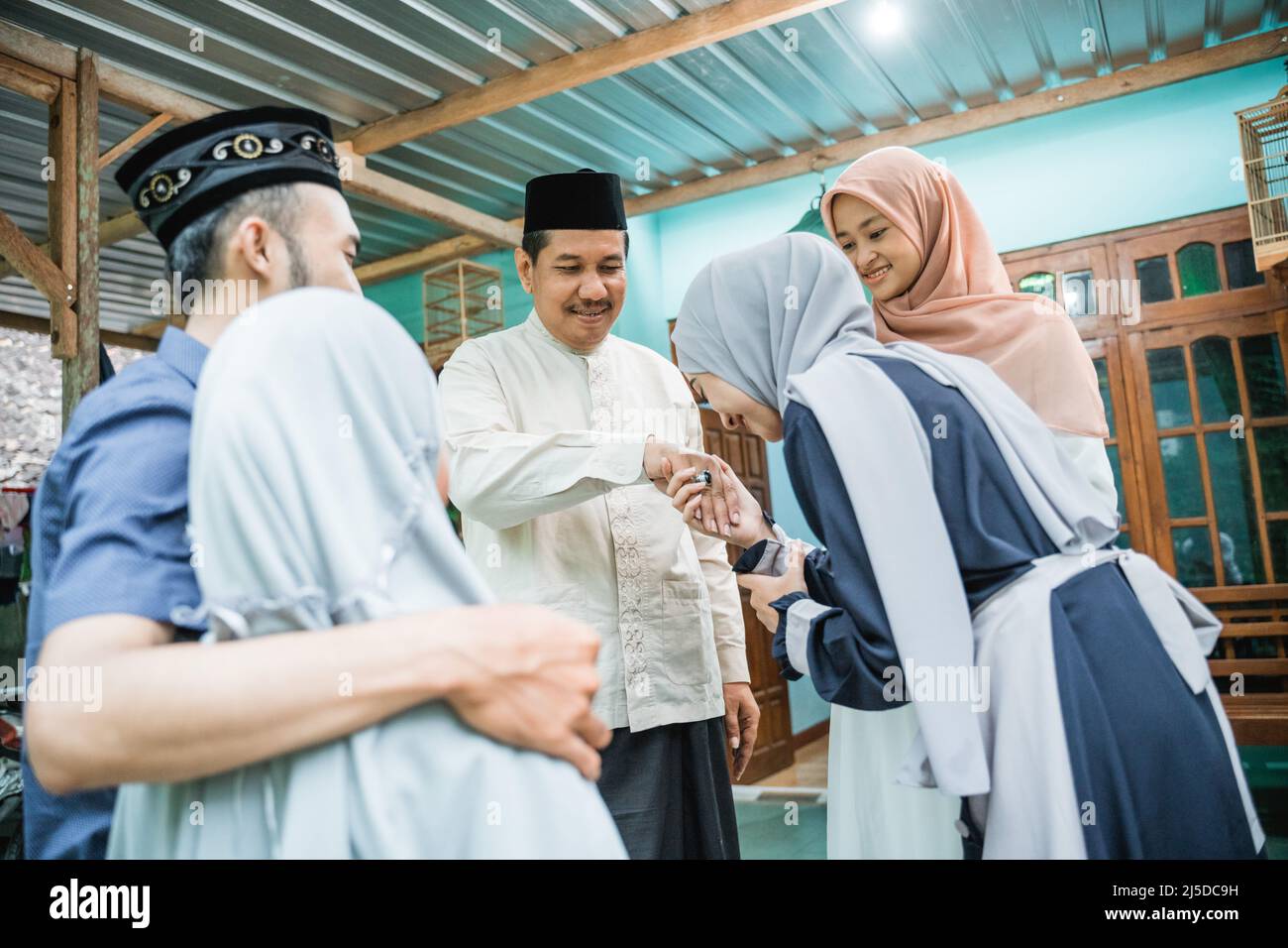 muslim family coming back home and shake their parent's hand Stock ...