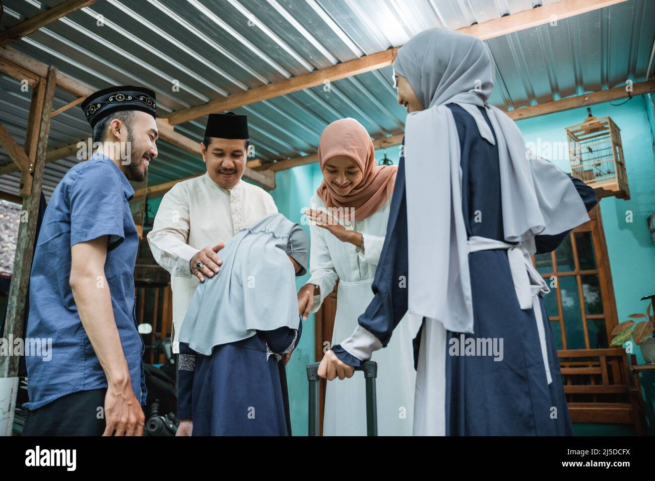 muslim family coming back home and shake their parent's hand Stock ...