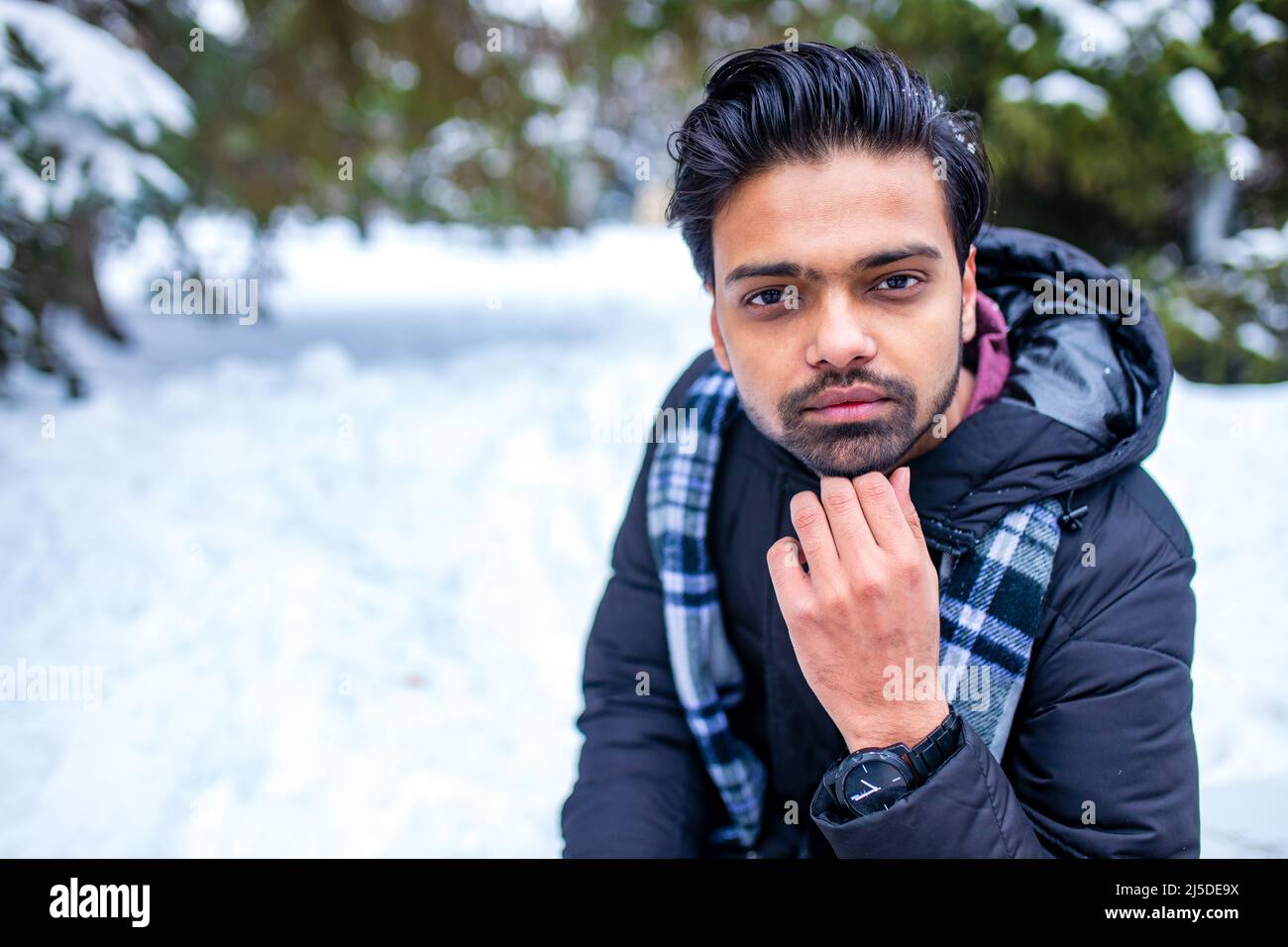 indian man enjoying snowflakes falling from upwards in forest Stock ...