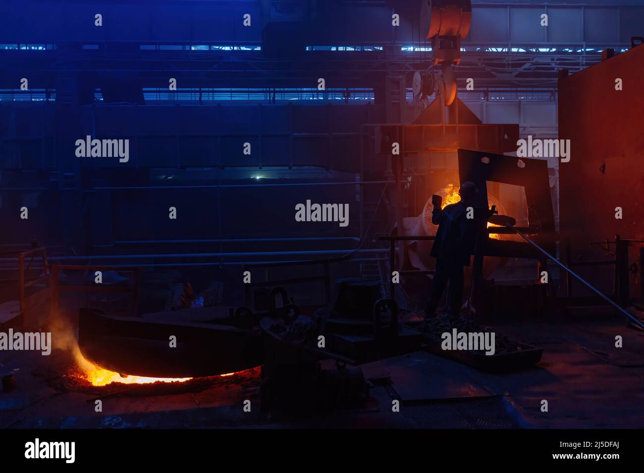 Worker operates metal casting process in metallurgical plant Stock ...