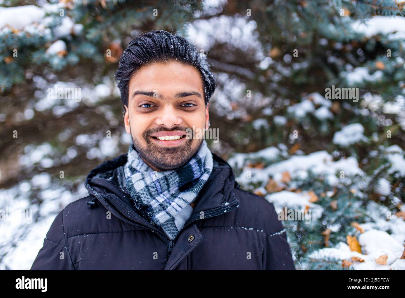 indian man enjoying snowflakes falling from upwards in forest Stock ...