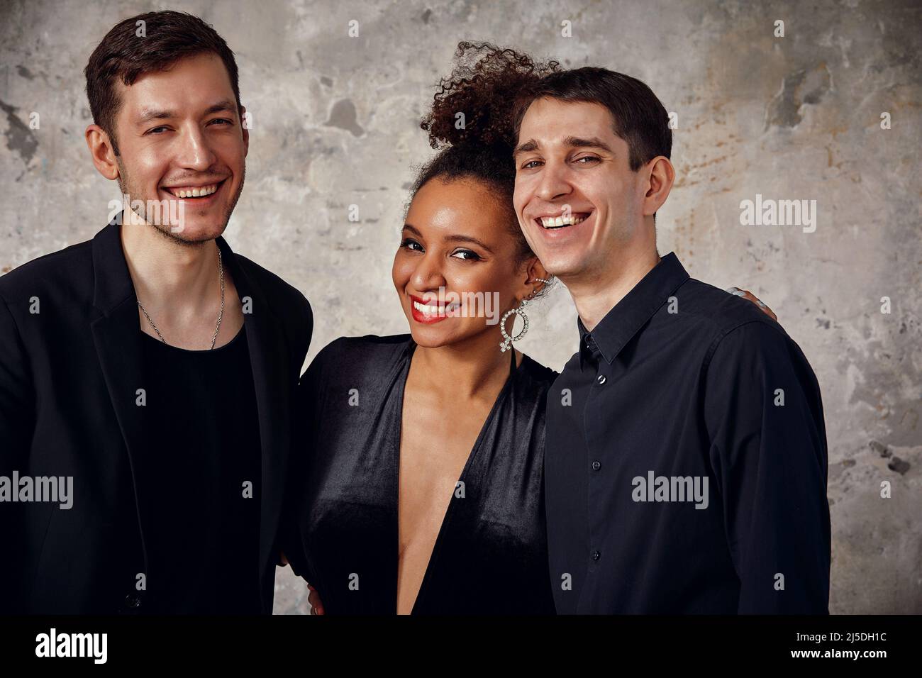 Portrait of diverse group of young people musical band playing with ...