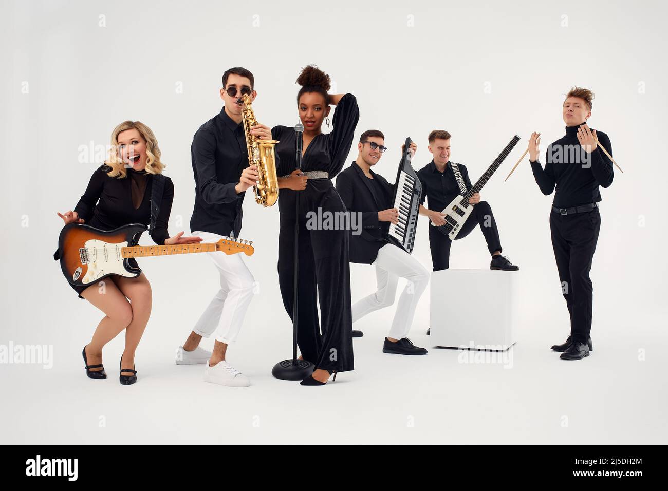 Portrait of diverse group of young people musical band playing with ...