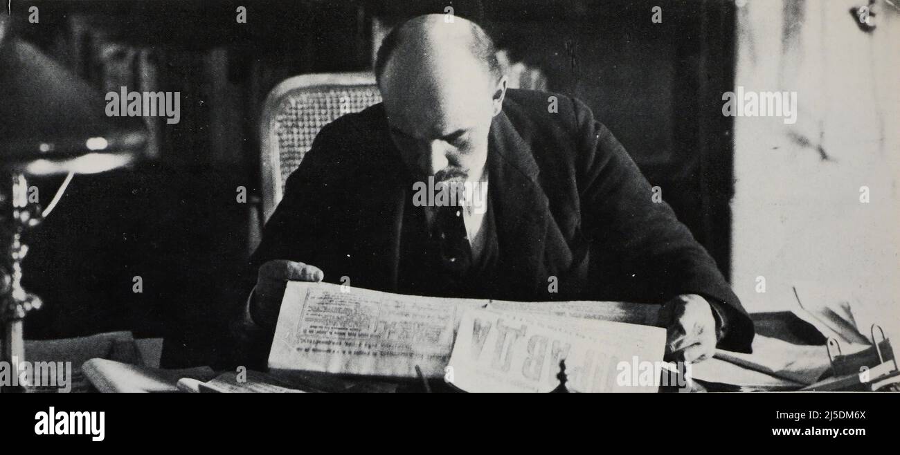 Eng translation : " Lenin at his desk in the Kremlin, reading Pravda ...