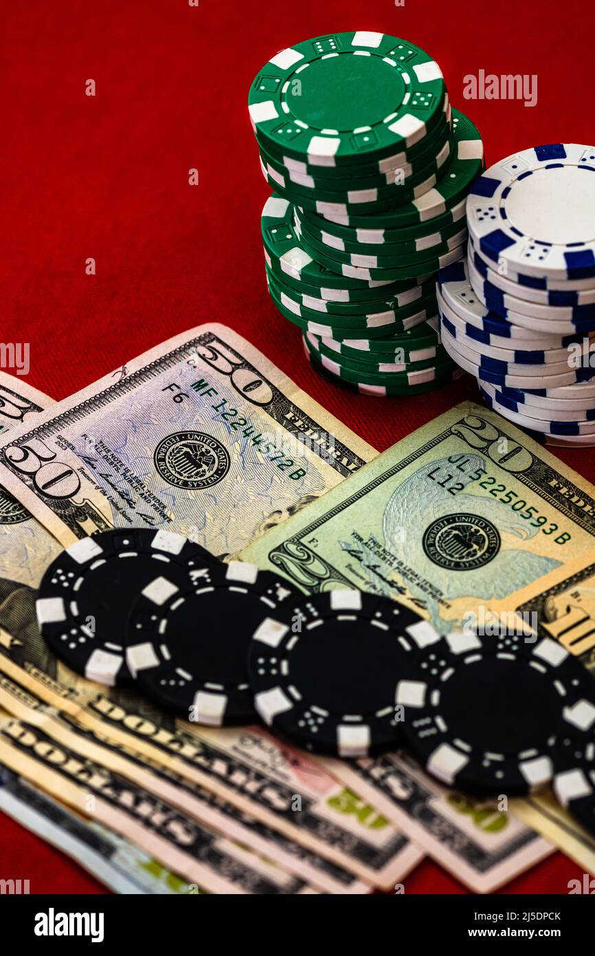 Stacks of poker chips with money on red background, USD currency Stock ...