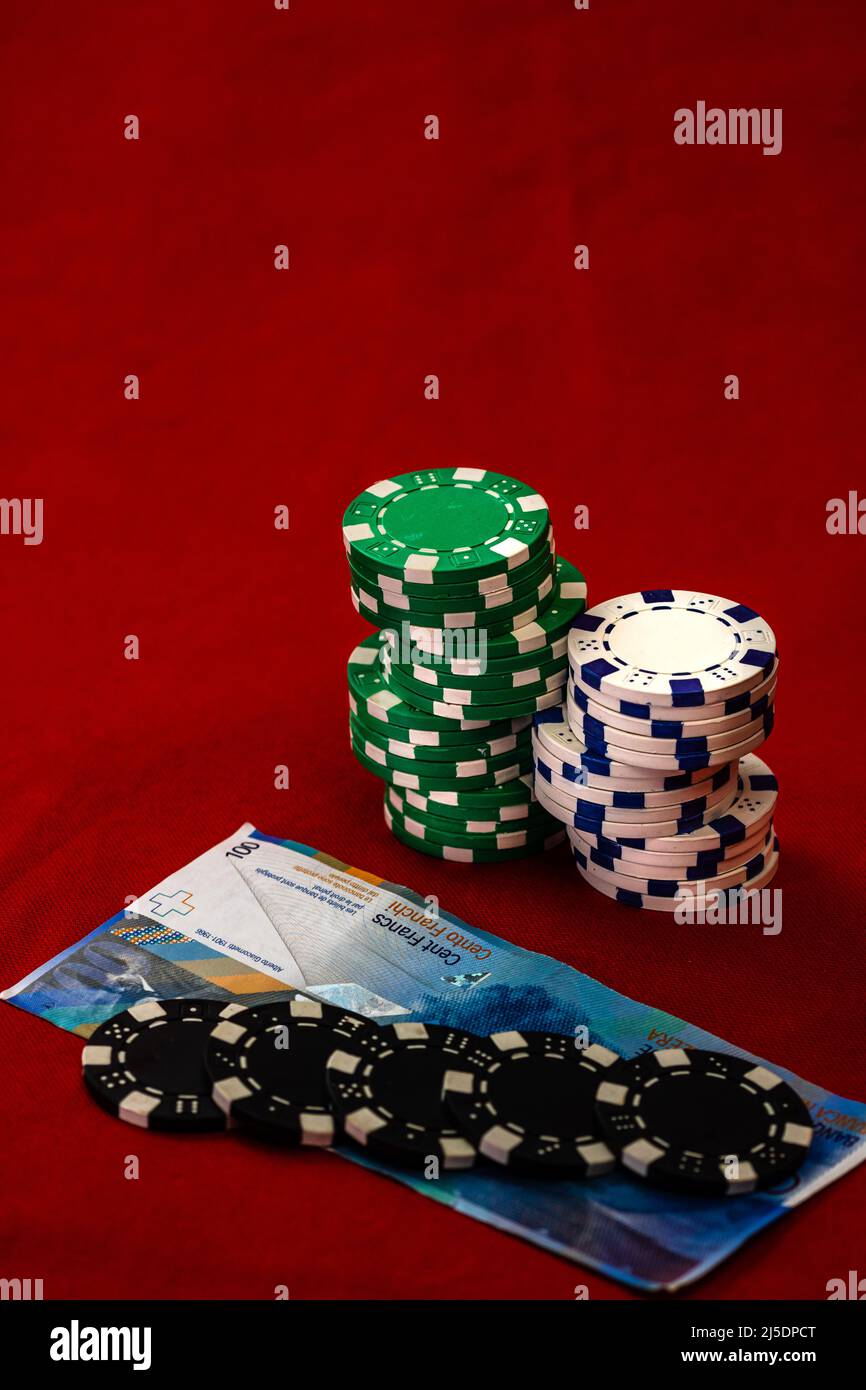 Stacks of poker chips with money on red background, CHF currency Stock ...