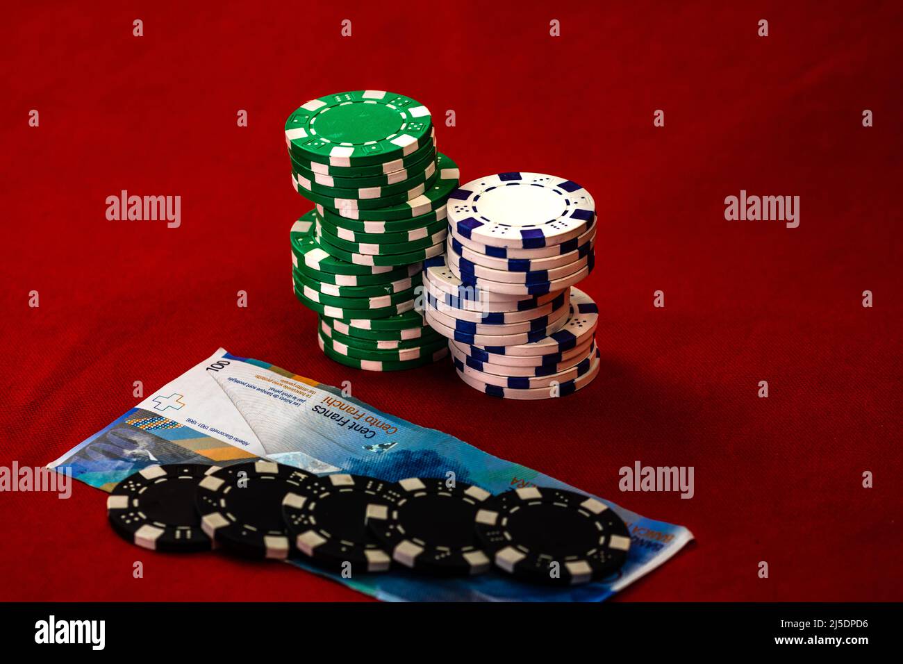 Stacks of poker chips with money on red background, CHF currency Stock ...