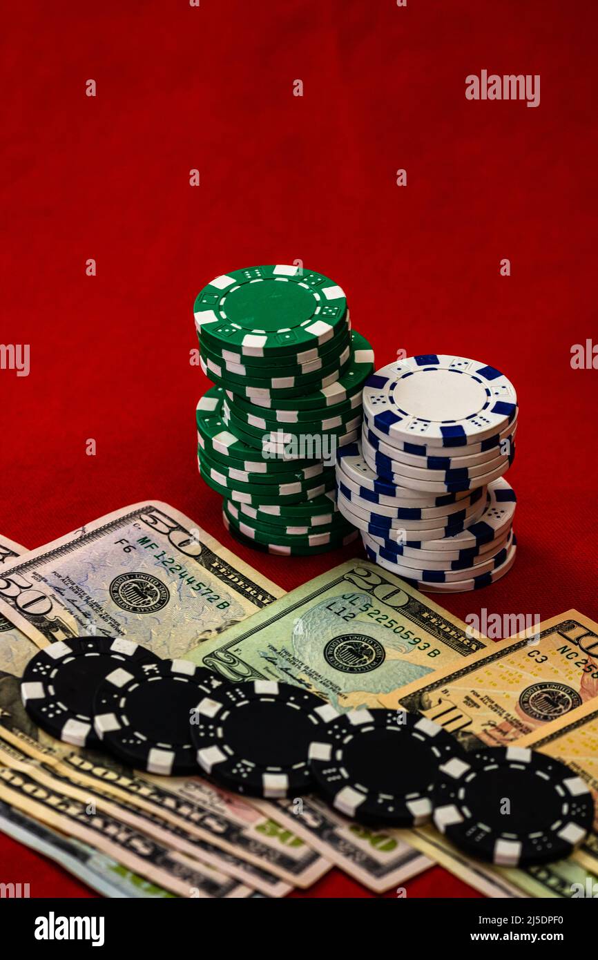 Stacks of poker chips with money on red background, USD currency Stock ...