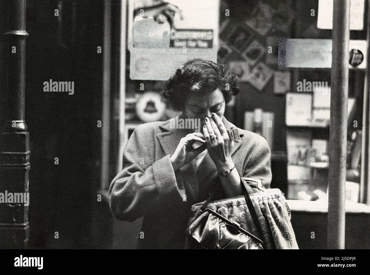Half-Length Portrait of Woman lighting a Match, New York City, New York ...