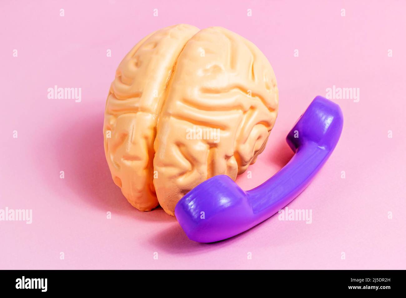 Human brain using dial phone on light pink background. Phone addiction ...