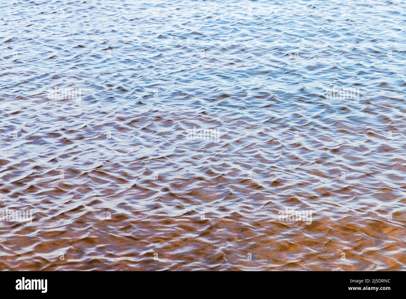 Sea water surface with ripple reflections and sandy seabed, abstract ...