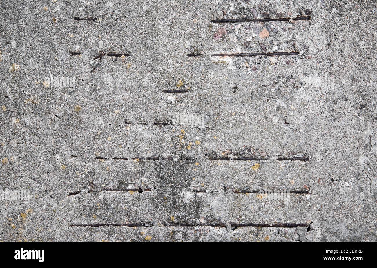 Gray rough concrete wall with rusty reinforcement, grungy background ...