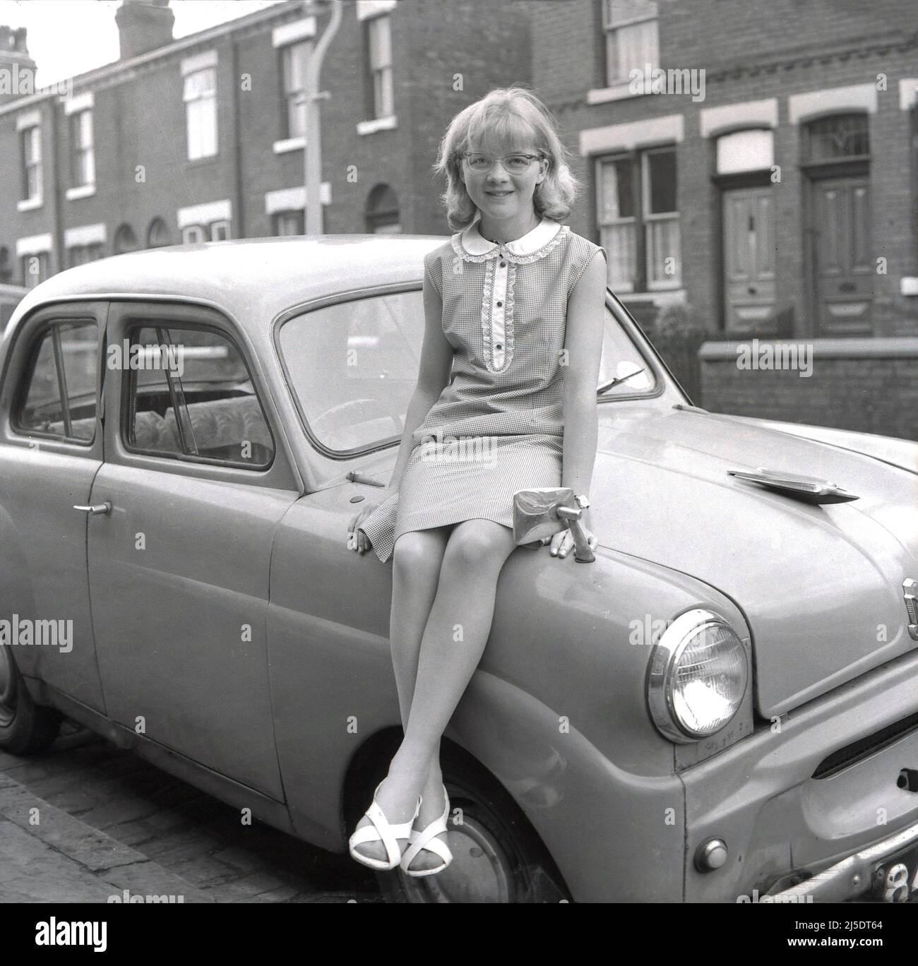 1959, historical, outside in street of victorian terraced houses, a ...