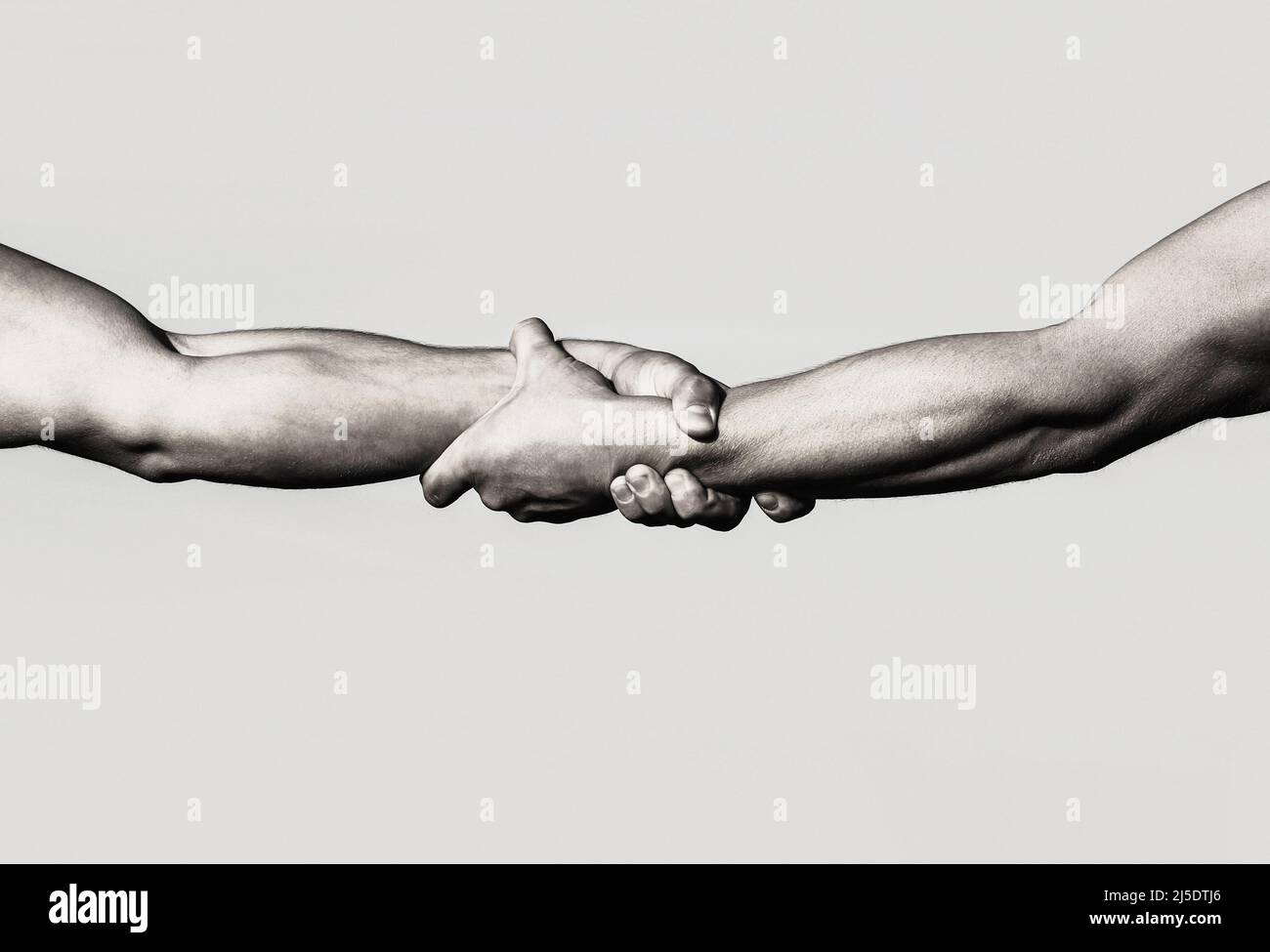 A friendly handshake. Two hands, shaking hands. Two hands, helping arm ...