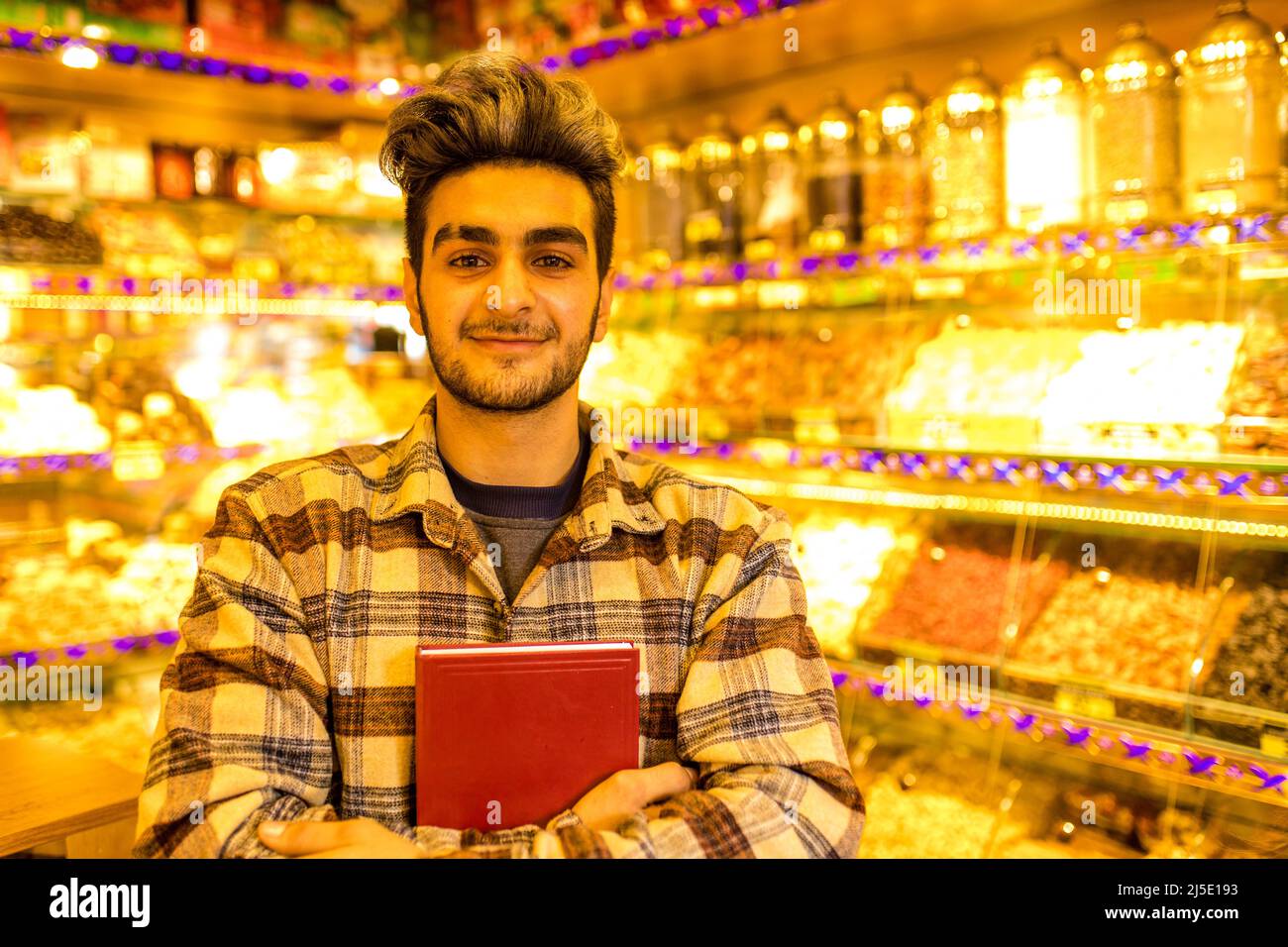Turkish seller man in the bazaar serving customers with Turkey products ...
