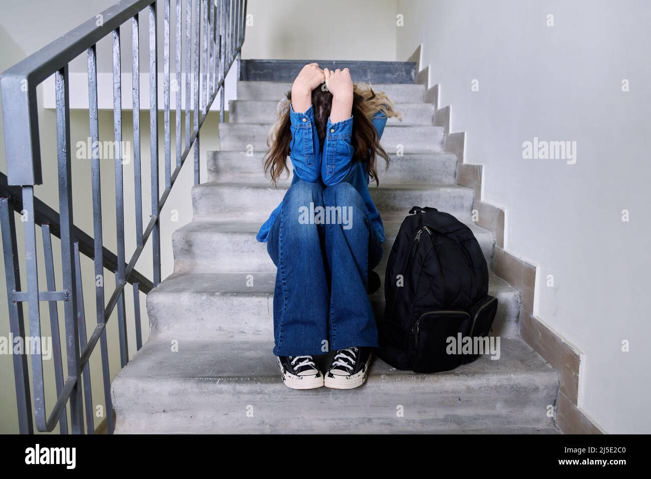 Sad frustrated young woman sitting on the steps Stock Photo - Alamy