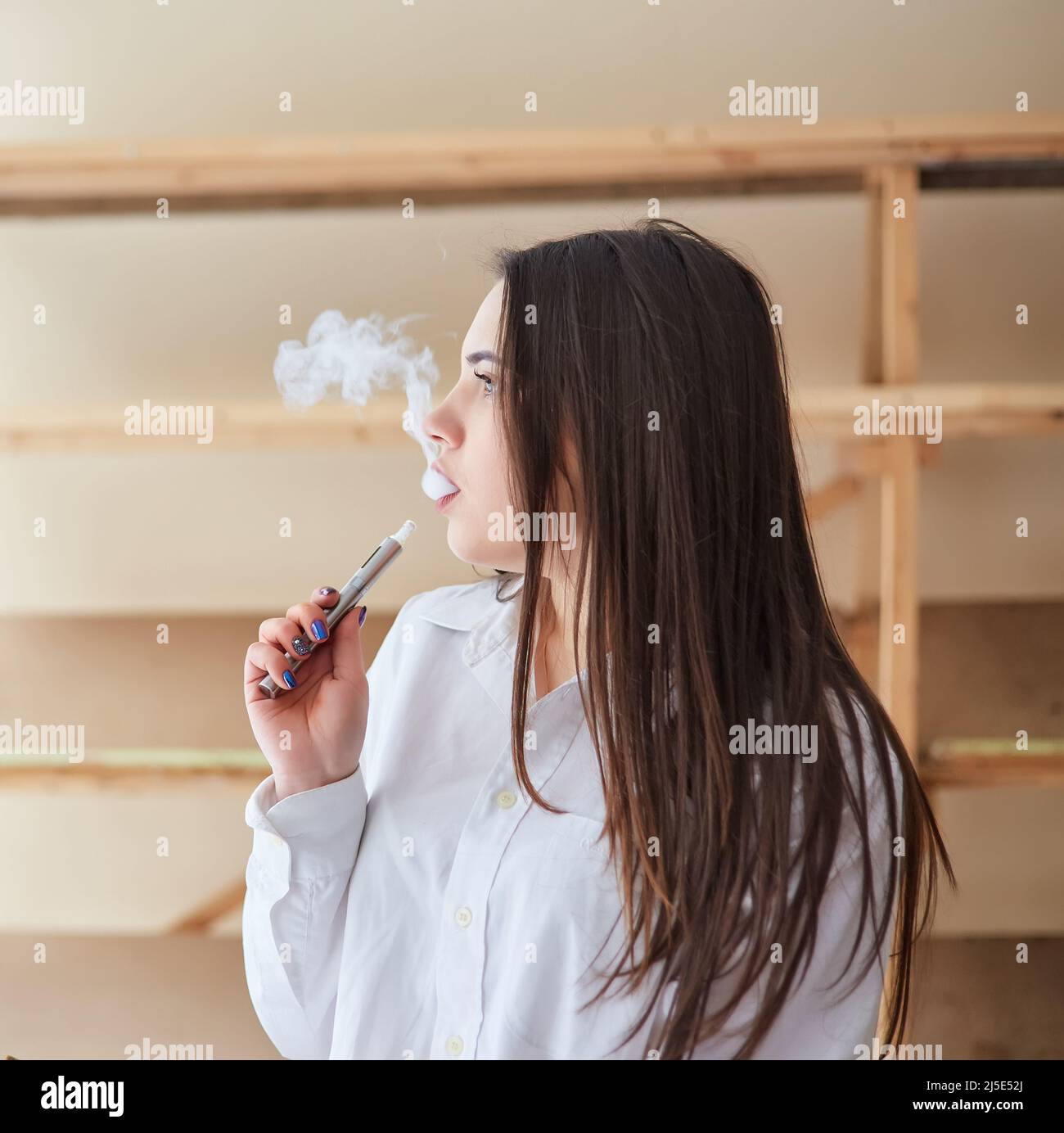 Happy vaper girl with vaping device in hand.Quit smoking nicotine ...