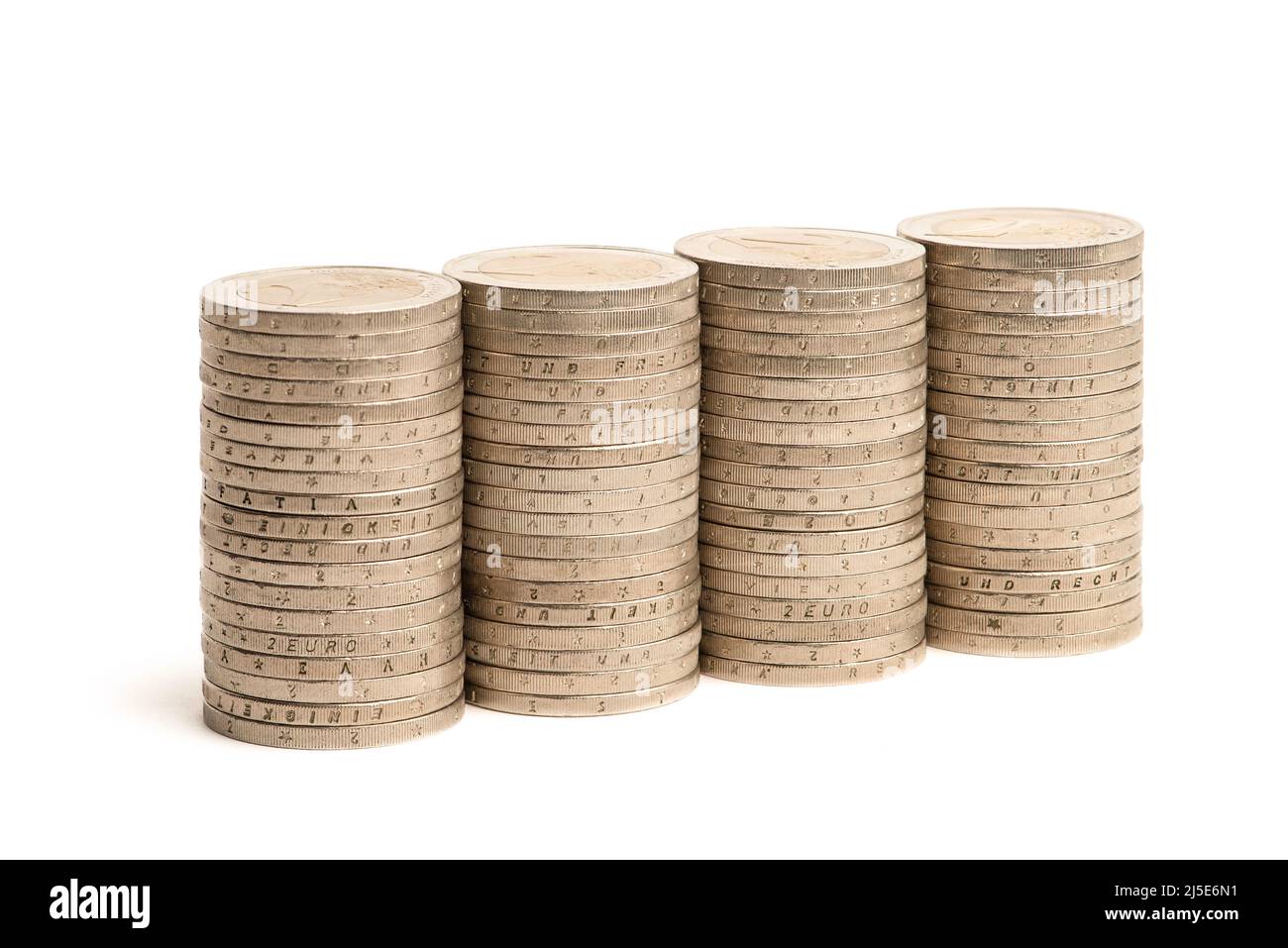 Stacks of coins on a white isolated background. 2 euro coins in a stack ...