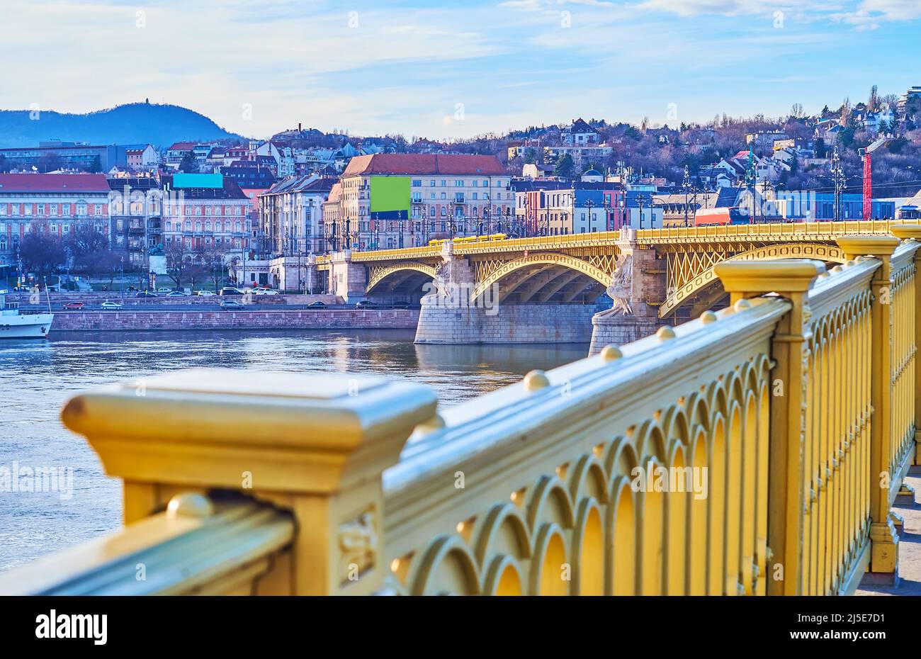 The closeup of the bright yellow metal rails of the Margaret Bridge ...