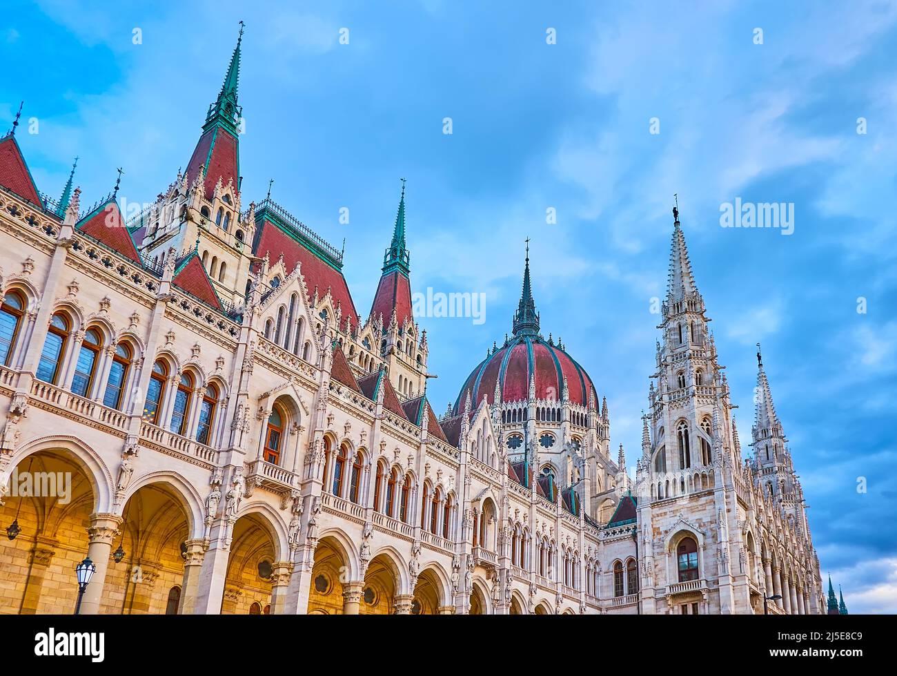 The facade wall of Hungarian Parliament with arcades, pillars, carvings ...