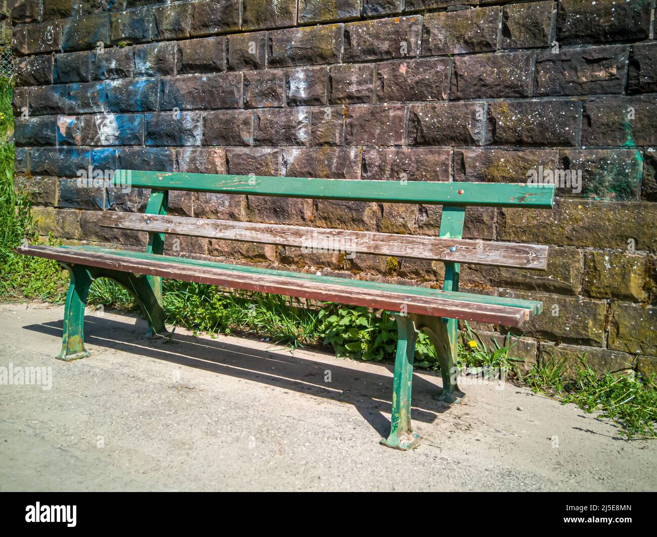 typical wooden public bench in need of repair in Germany in front of ...