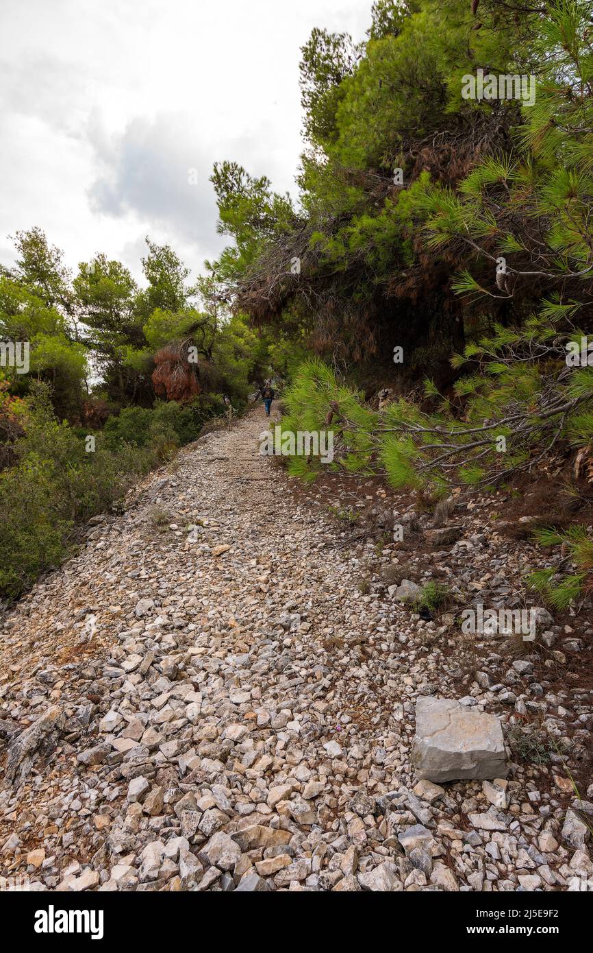 Walking aesthetic path at mount Hymettus. A woman is walking on mount ...
