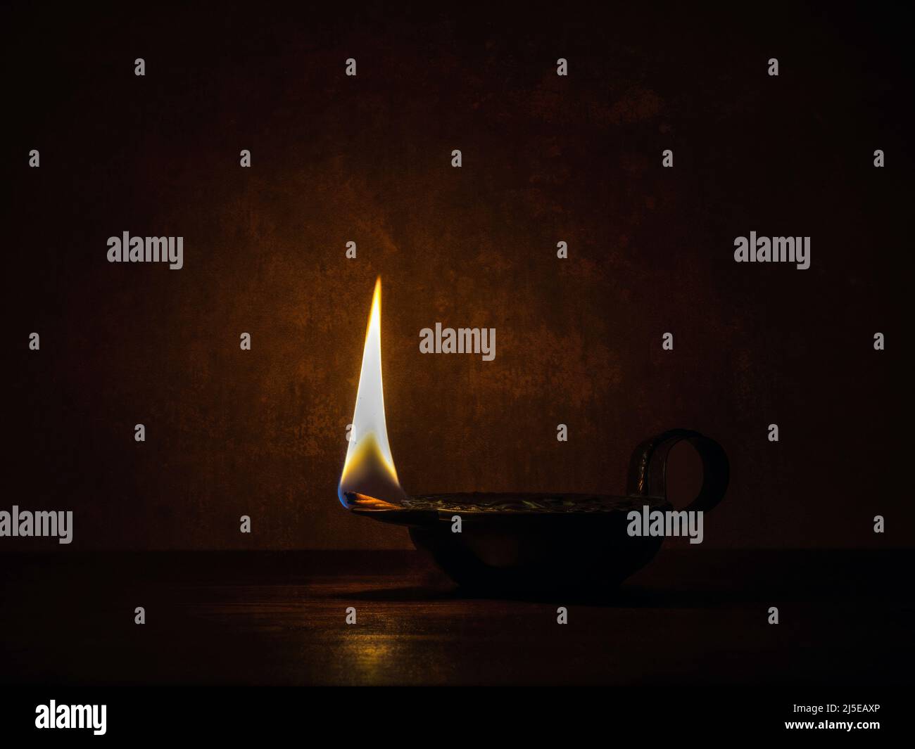 Vintage small oil lamp with flame, light in darkness Stock Photo - Alamy