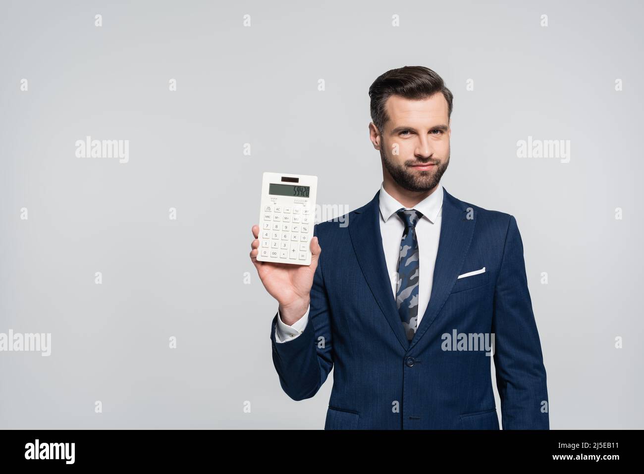 Bearded man showing calculator hi-res stock photography and images - Alamy