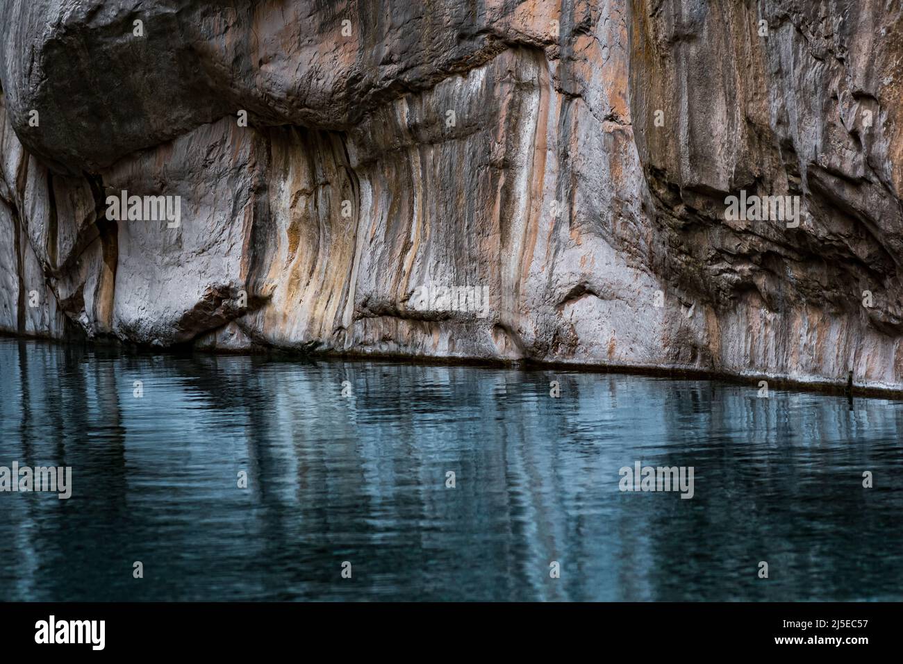 clean blue stream with rocky banks at the bottom of a deep canyon Stock ...