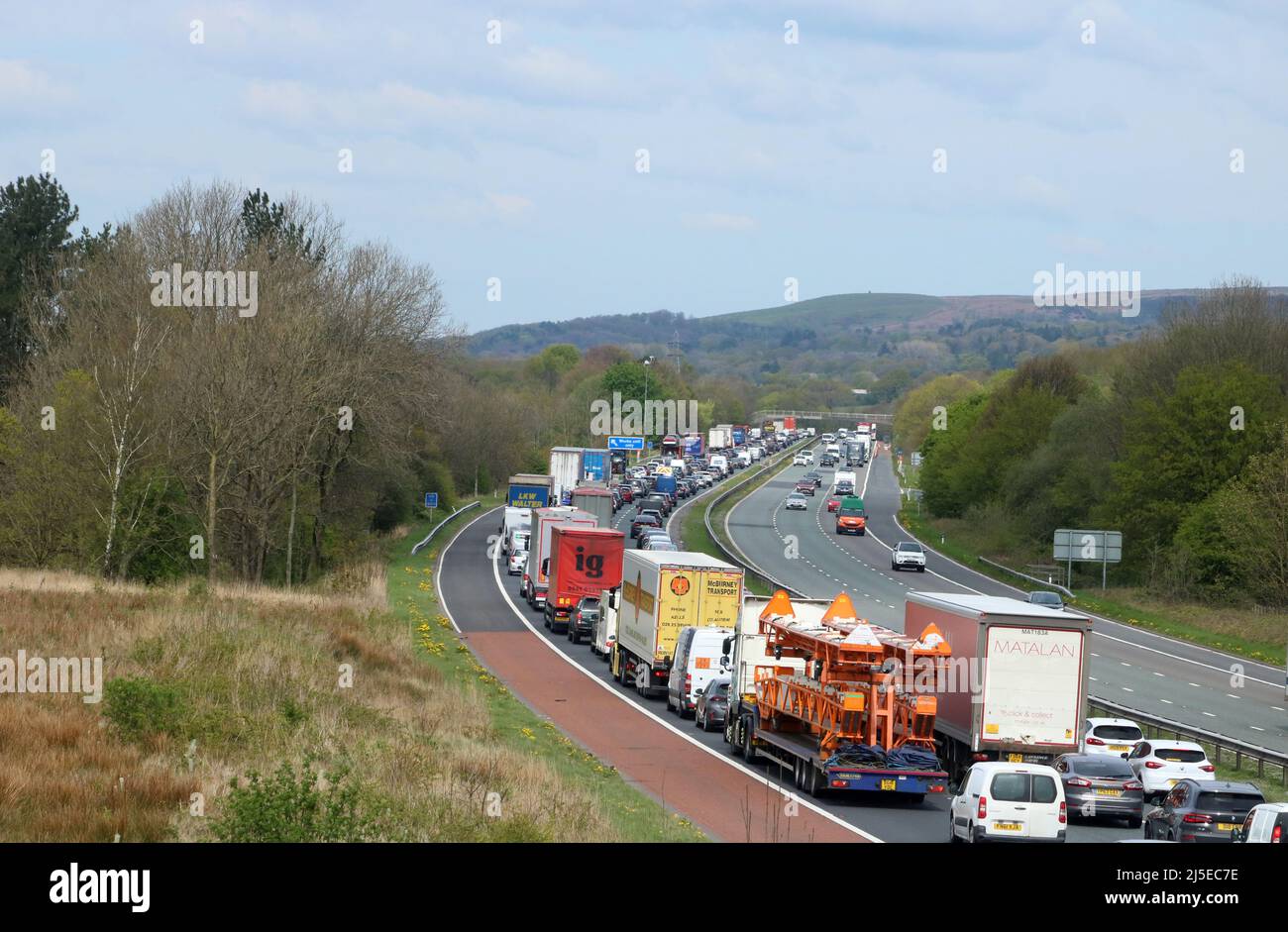 Slow moving traffic on M6 motorway in Lancashire countryside near ...