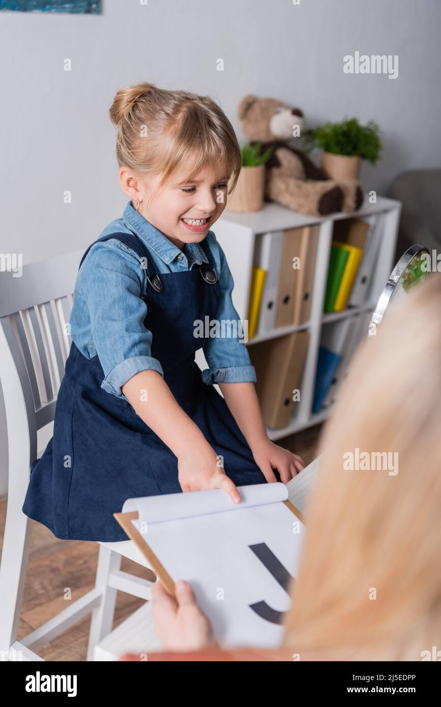 Teacher pointing to letter in classroom hi-res stock photography and ...