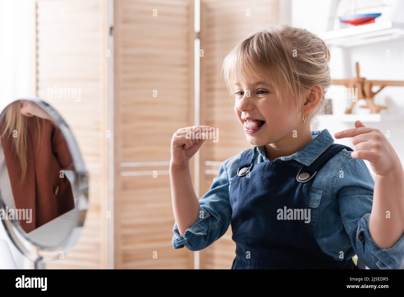Pupil pointing with fingers while talking near mirror during speech ...